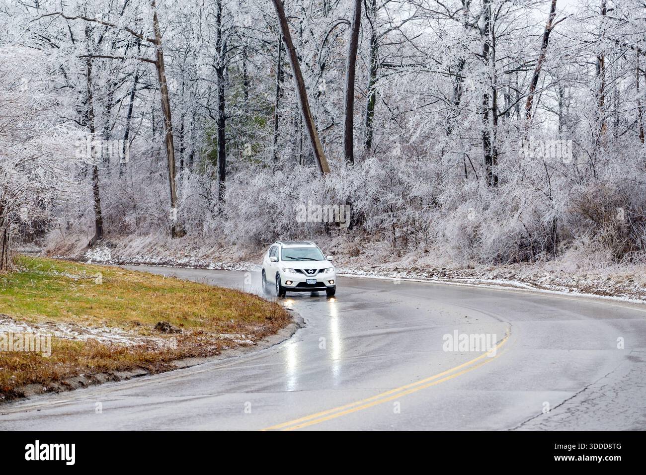 White car driving under extreme winter weather, freezing rain covering ...