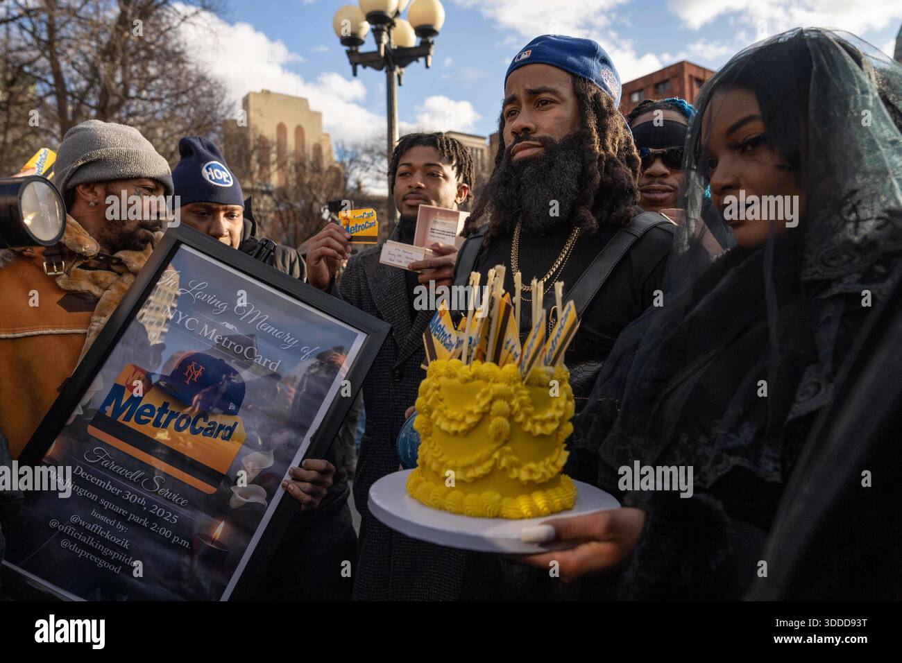 A person holds a Metrocard-themed cake during the Metrocard funeral ...
