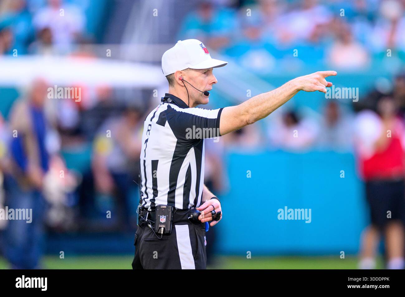 NFL referee Scott Novak points on the field during an NFL football game ...