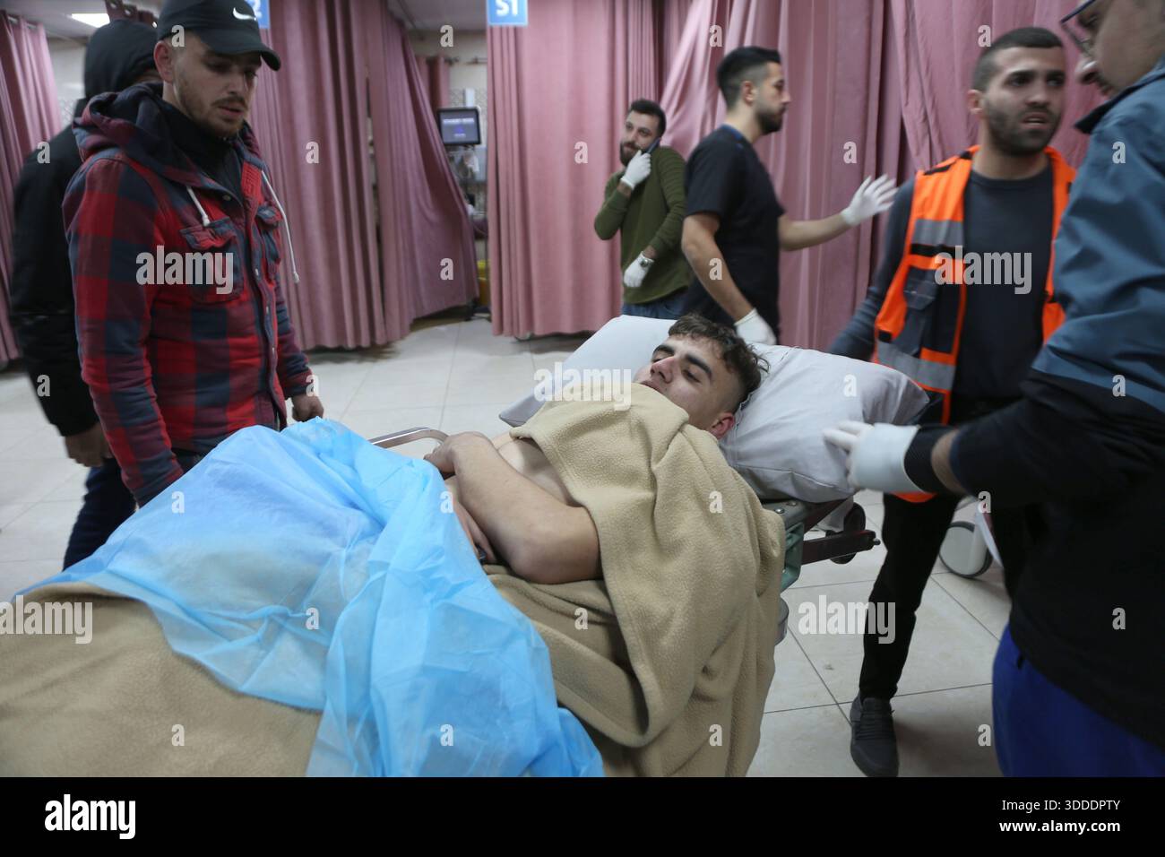 Palestinian medics evacuated a wounded Palestinian man after the ...