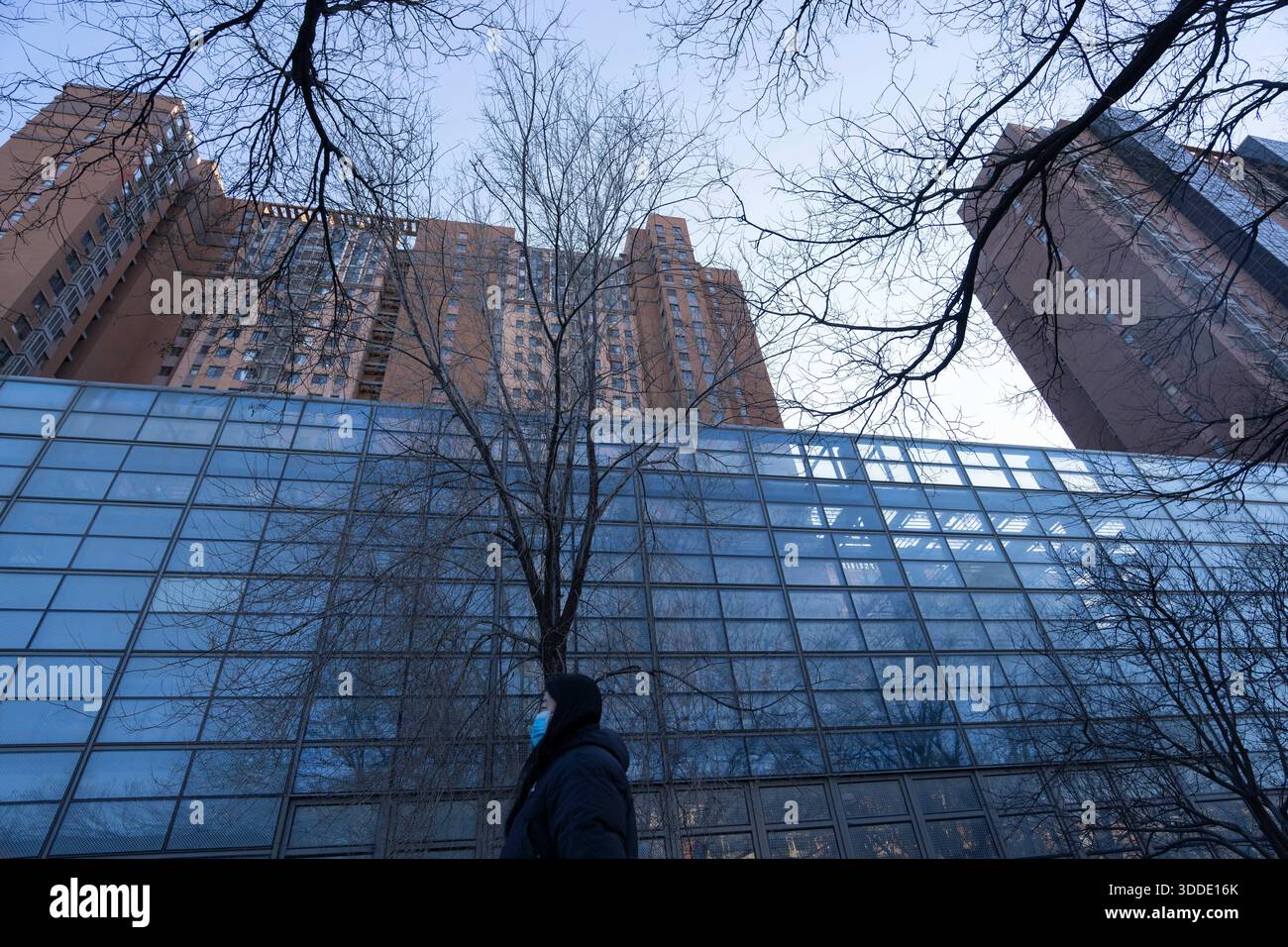 A woman passes by a Vanke residential complex in the district of ...
