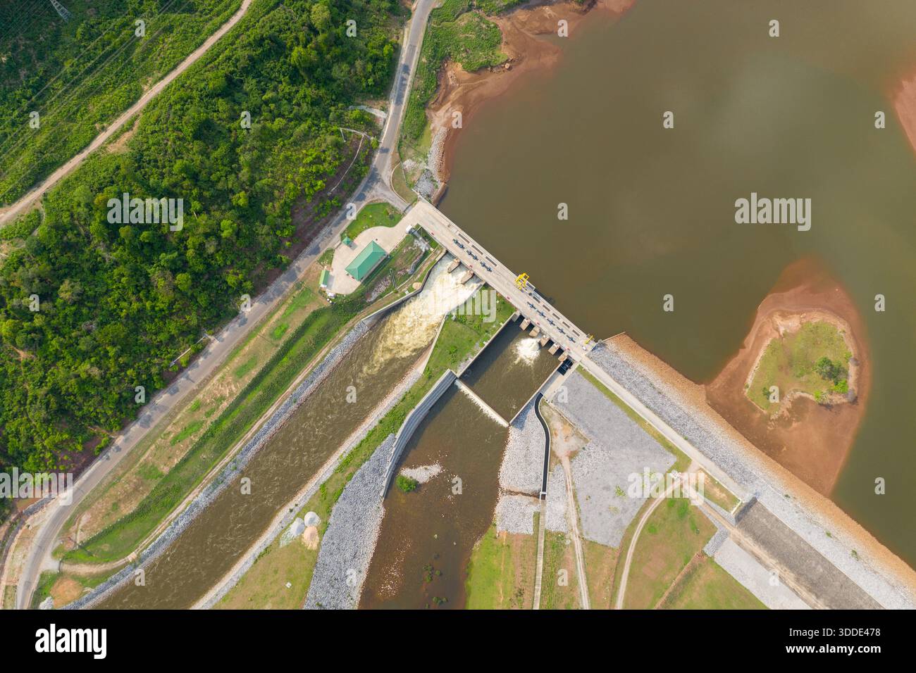 Overhead perspective of a hydroelectric dam with spillway, reservoir ...