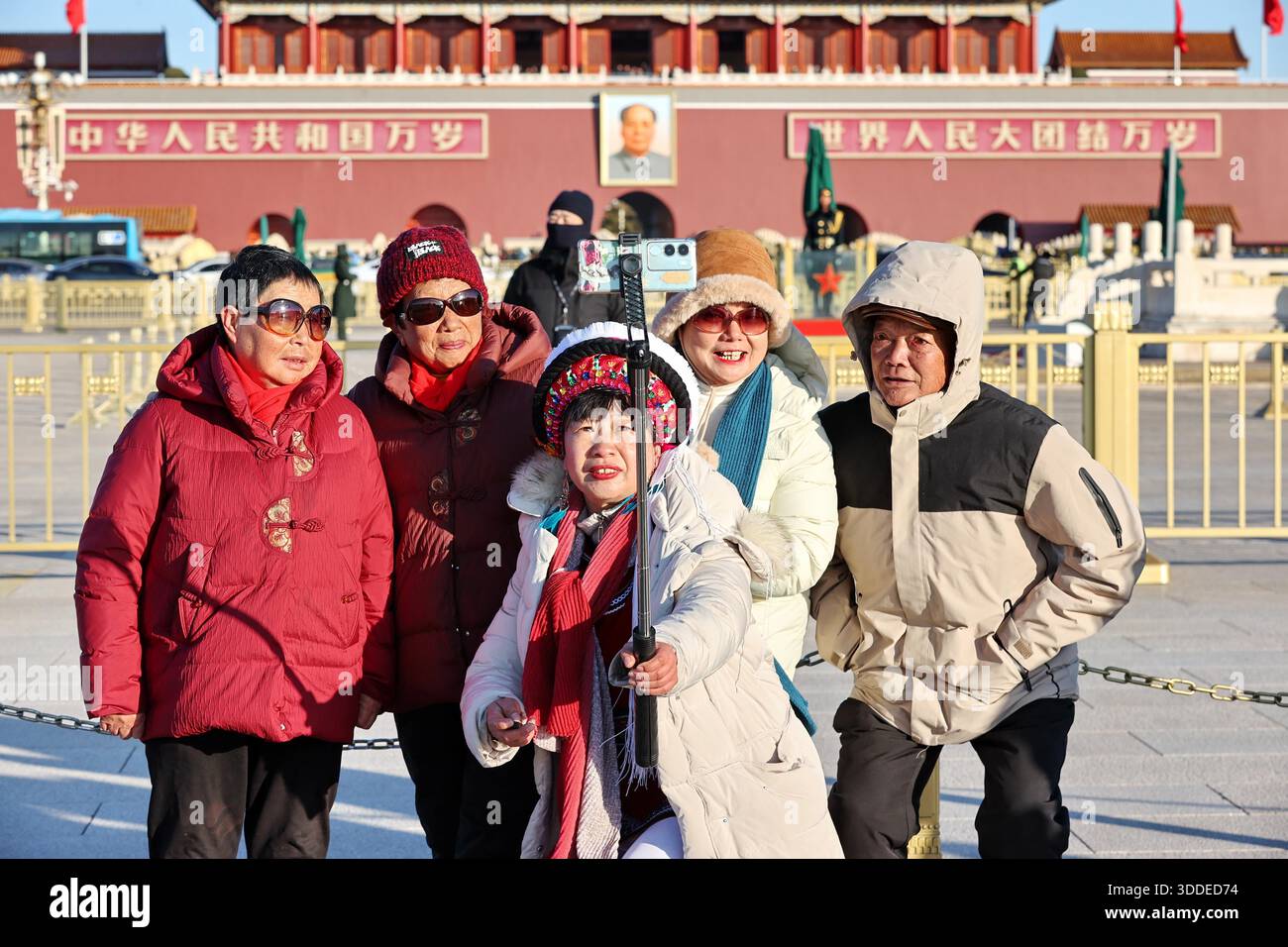 Tourists wear heavy winter clothes to visit Tiananmen Square in Beijing ...