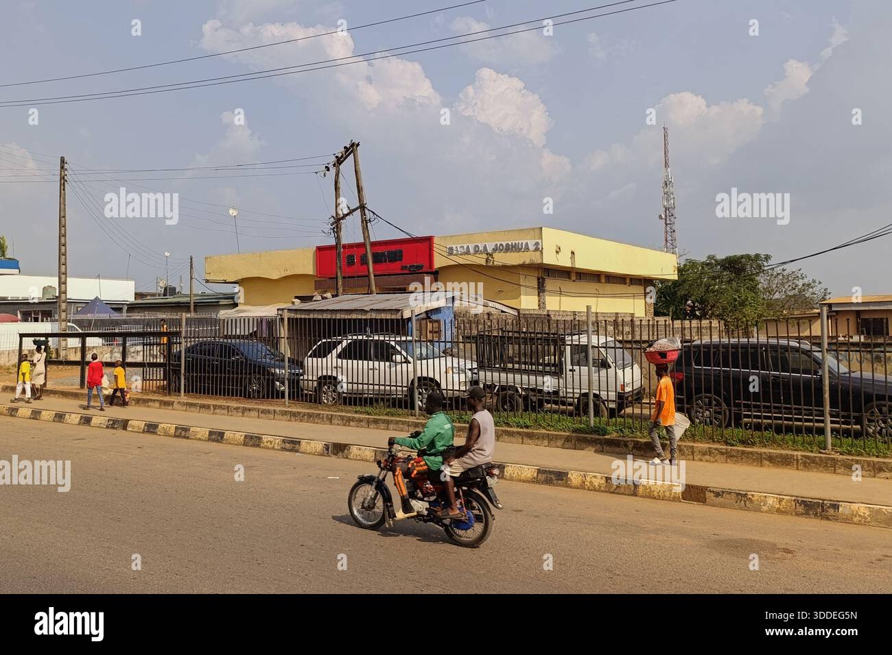 Pedestrians walk along a street near the building of Anthony Joshua's ...