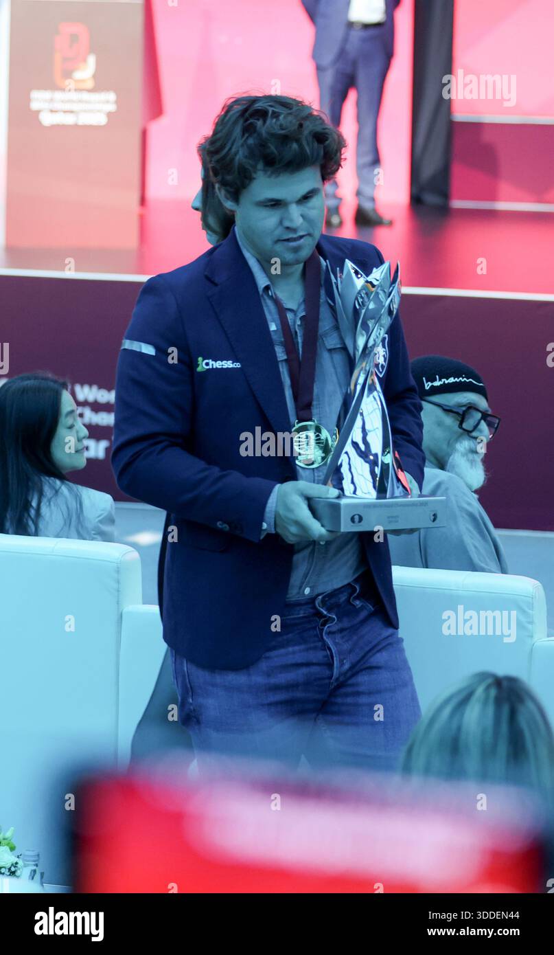 Norway's Magnus Carlsen walks with the winner's trophy during the Blitz ...