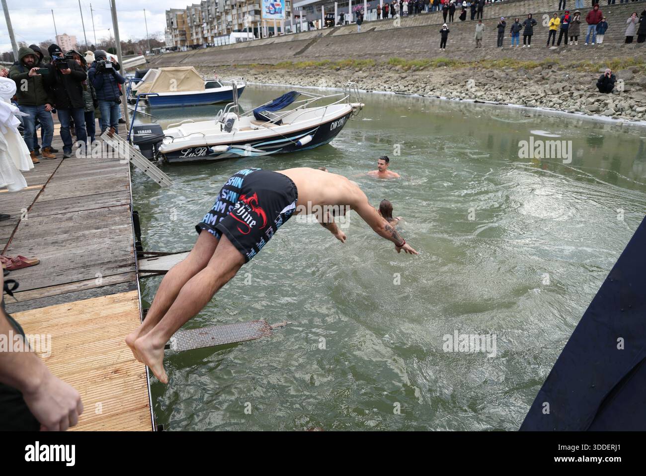 People take part in winter swimming on New Year's Eve in River Drava in ...