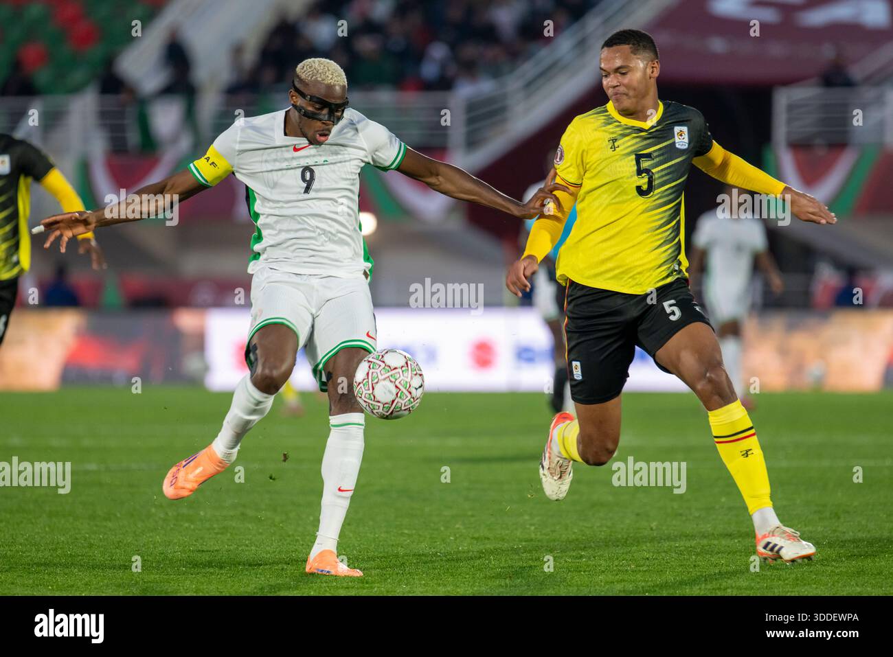 Victor Osimhen of Nigeria fights for the ball with Toby Sibbick of ...