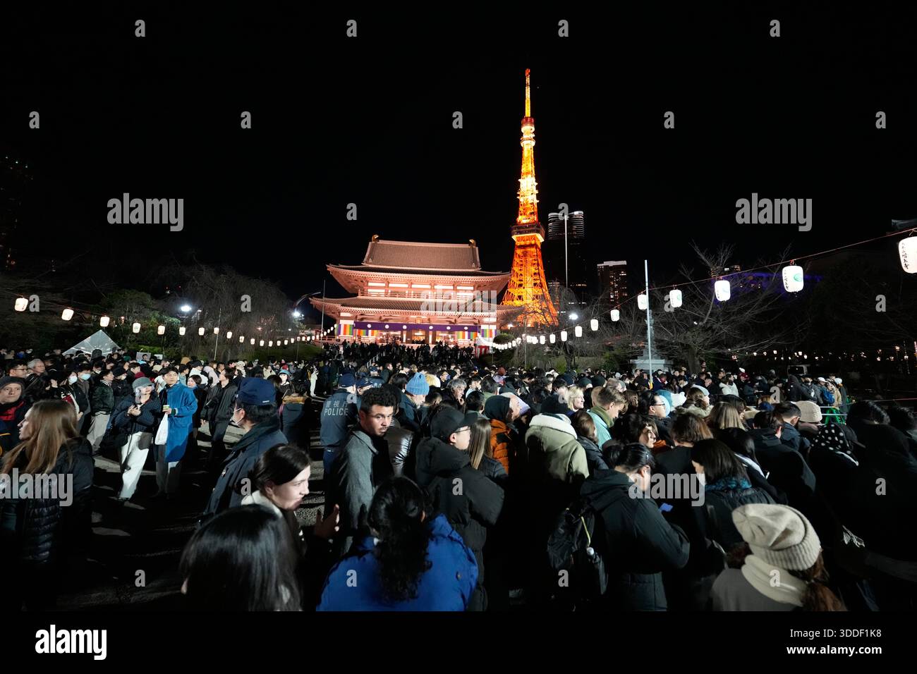 People gather to celebrate the New Year at the Zojoji Buddhist temple ...