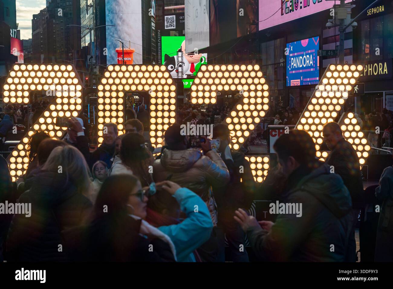 Visitors to Times Square in New York flock to the display of the “2026 ...