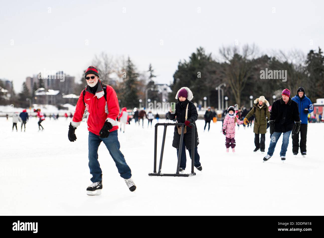 A skater uses a skate assist device while skating along the Rideau ...