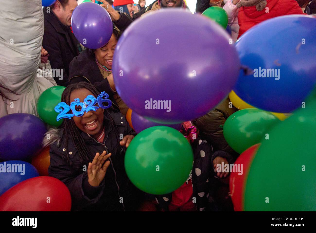 Cori Johnson, 9, left, of Washington, wears 2026 glasses during a noon ...
