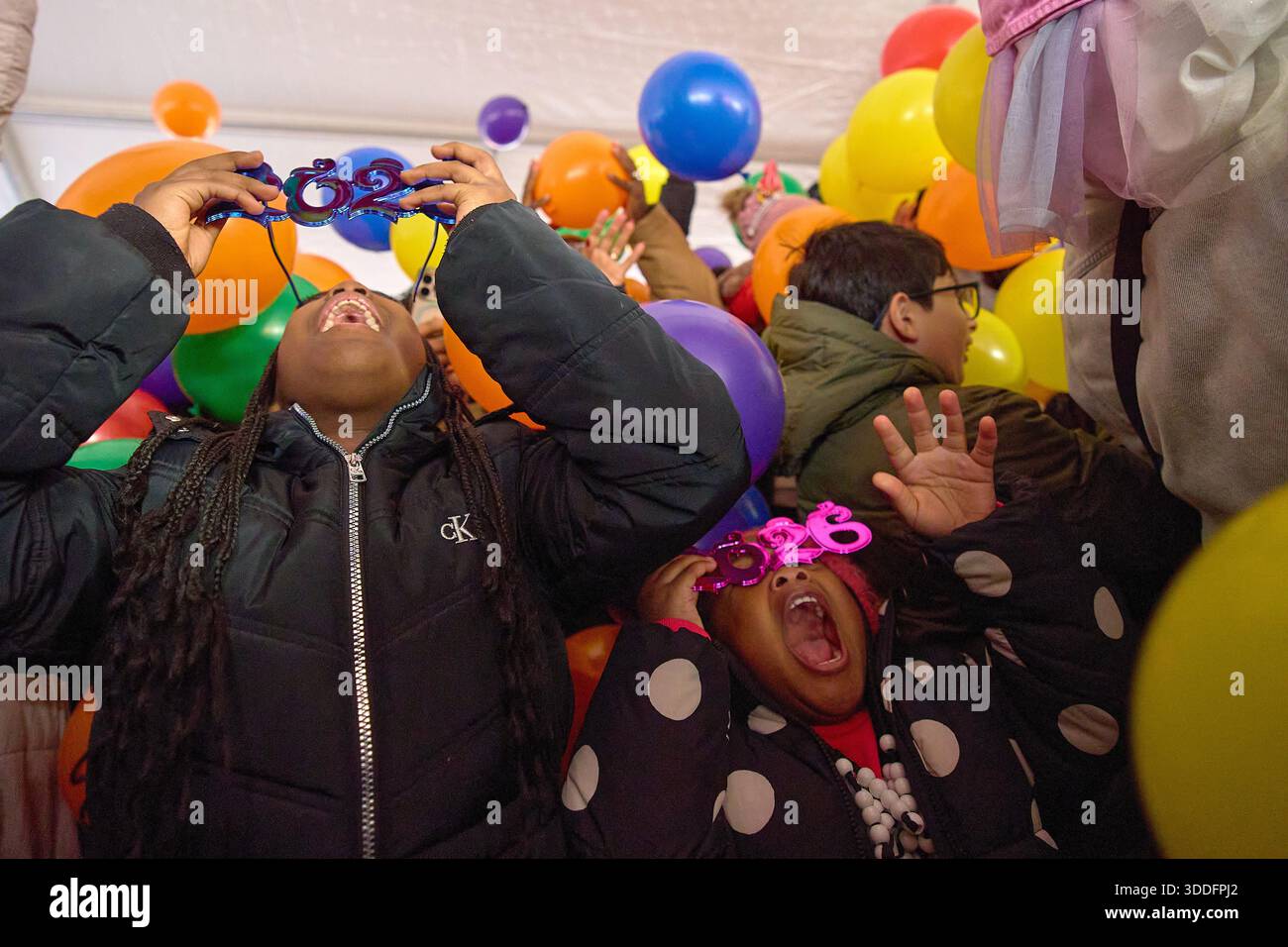 Cori Johnson, 9, left, and Kori Simms, 6, both of Washington, wear 2026 ...