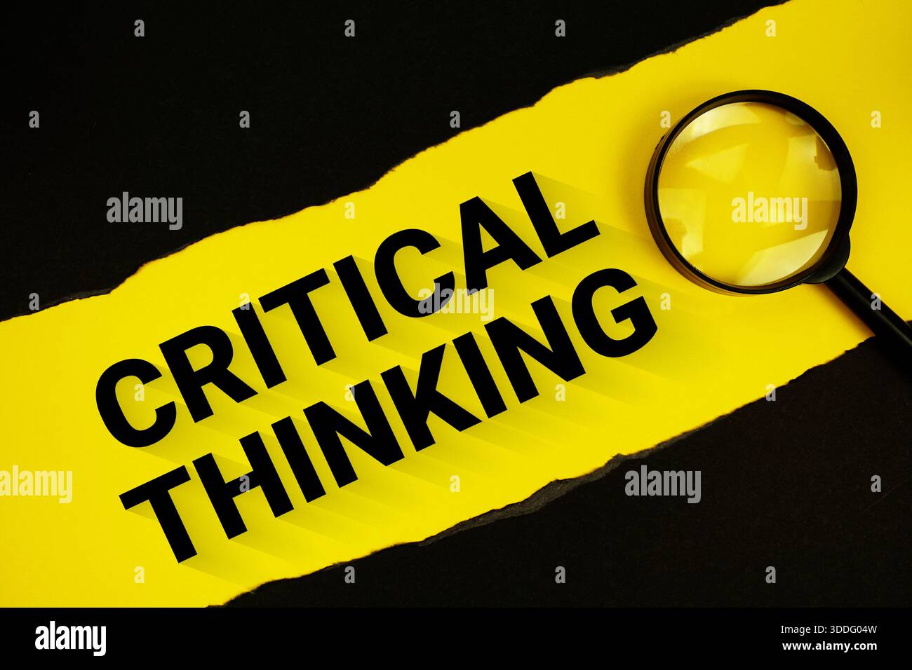 Critical Thinking text on yellow with black paper torn ripped and ...