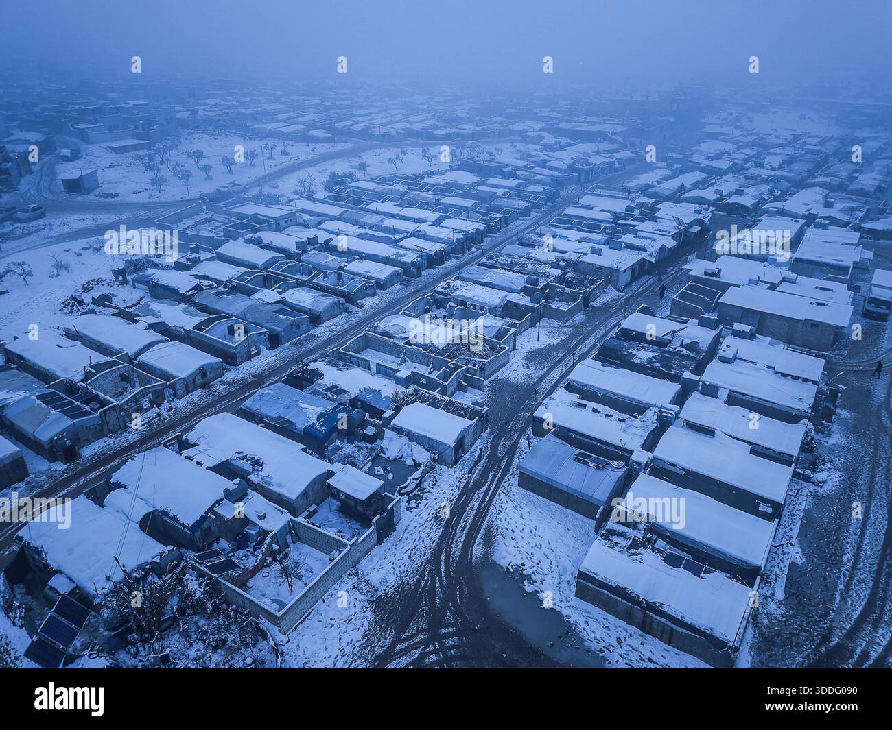 31 December 2024, Syria, Idlib: An aerial view shows houses covered in ...
