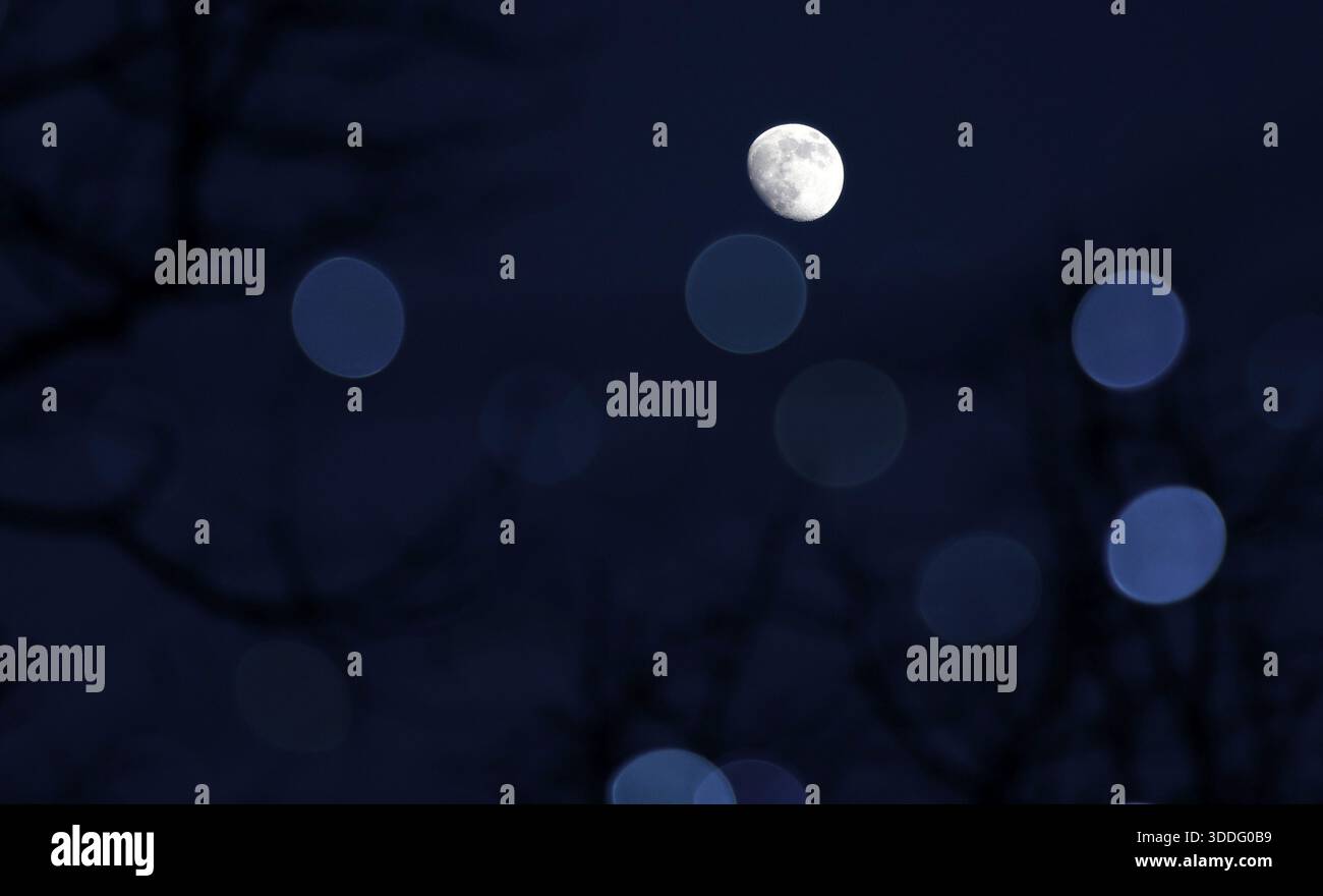 Brescia , Italy. 31th December 2025. The Moon is seen trough Christmas ...
