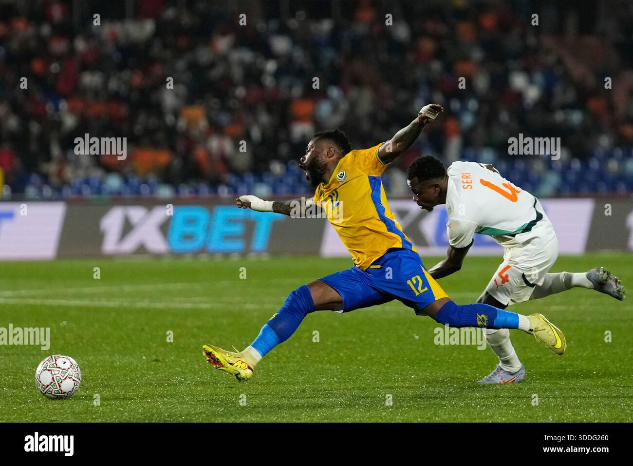 Uganda's Baba Alhassan is challenged by Ivory Coast's Jean-Michael Seri ...