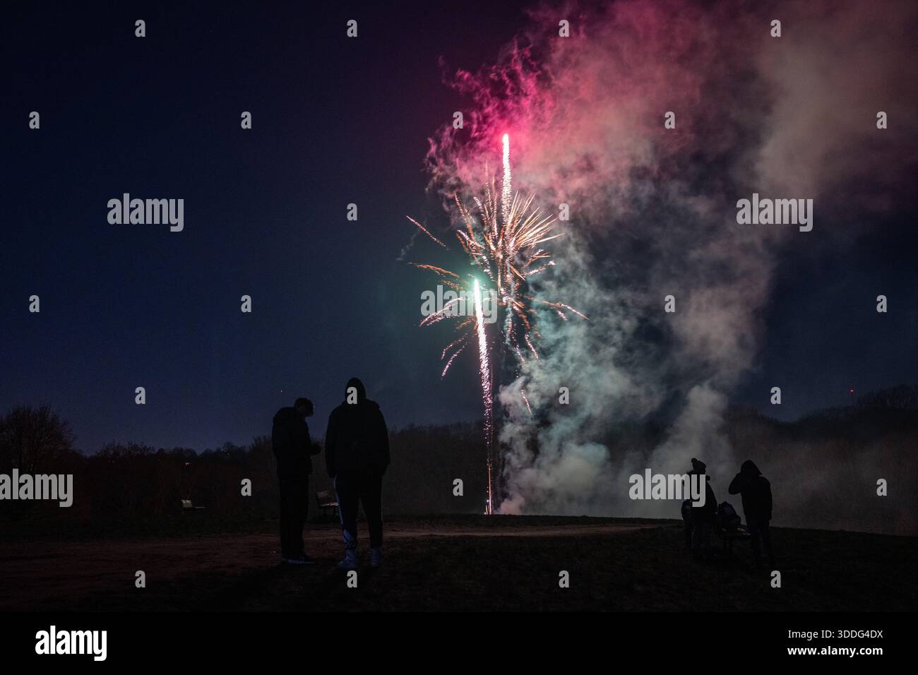 People watch as fireworks explode over Parliament Hill Viewpoint a ...