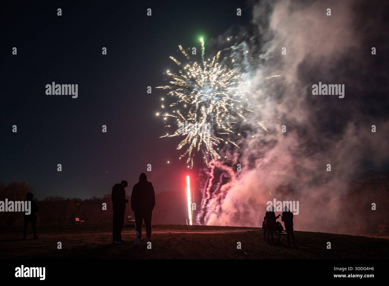 People watch as fireworks explode over Parliament Hill Viewpoint a ...