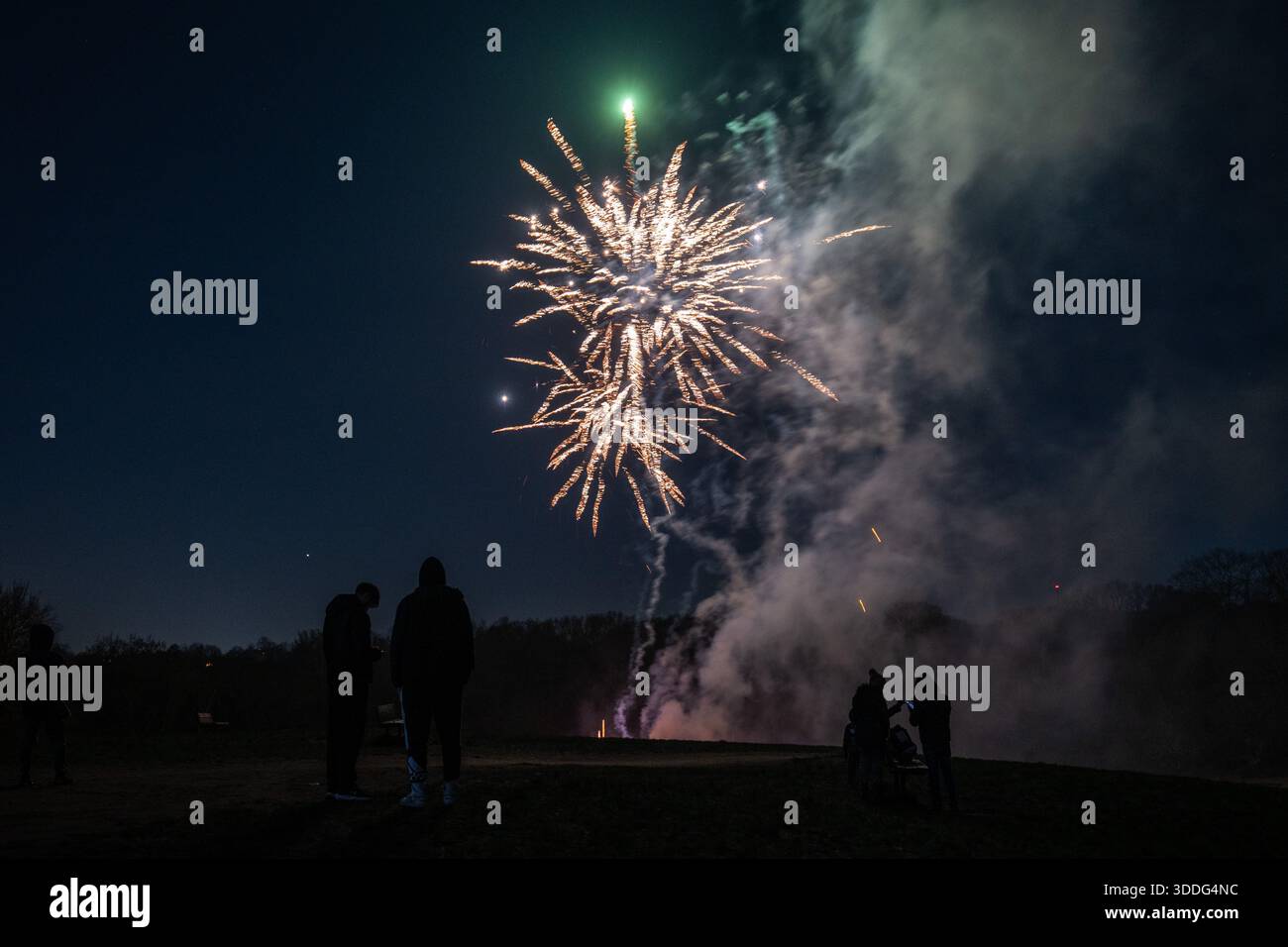 People watch as fireworks explode over Parliament Hill Viewpoint a ...