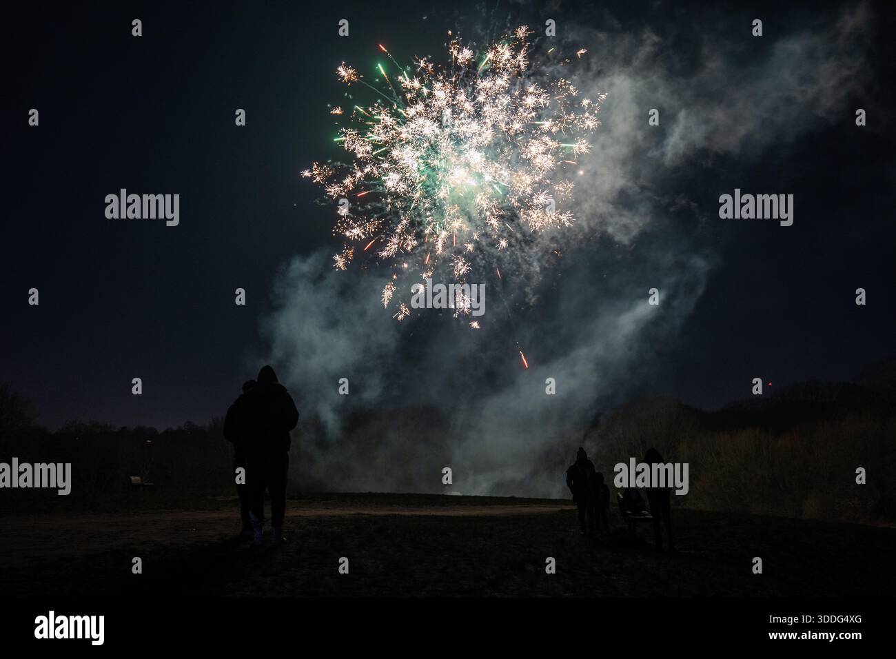 People watch as fireworks explode over Parliament Hill Viewpoint a ...