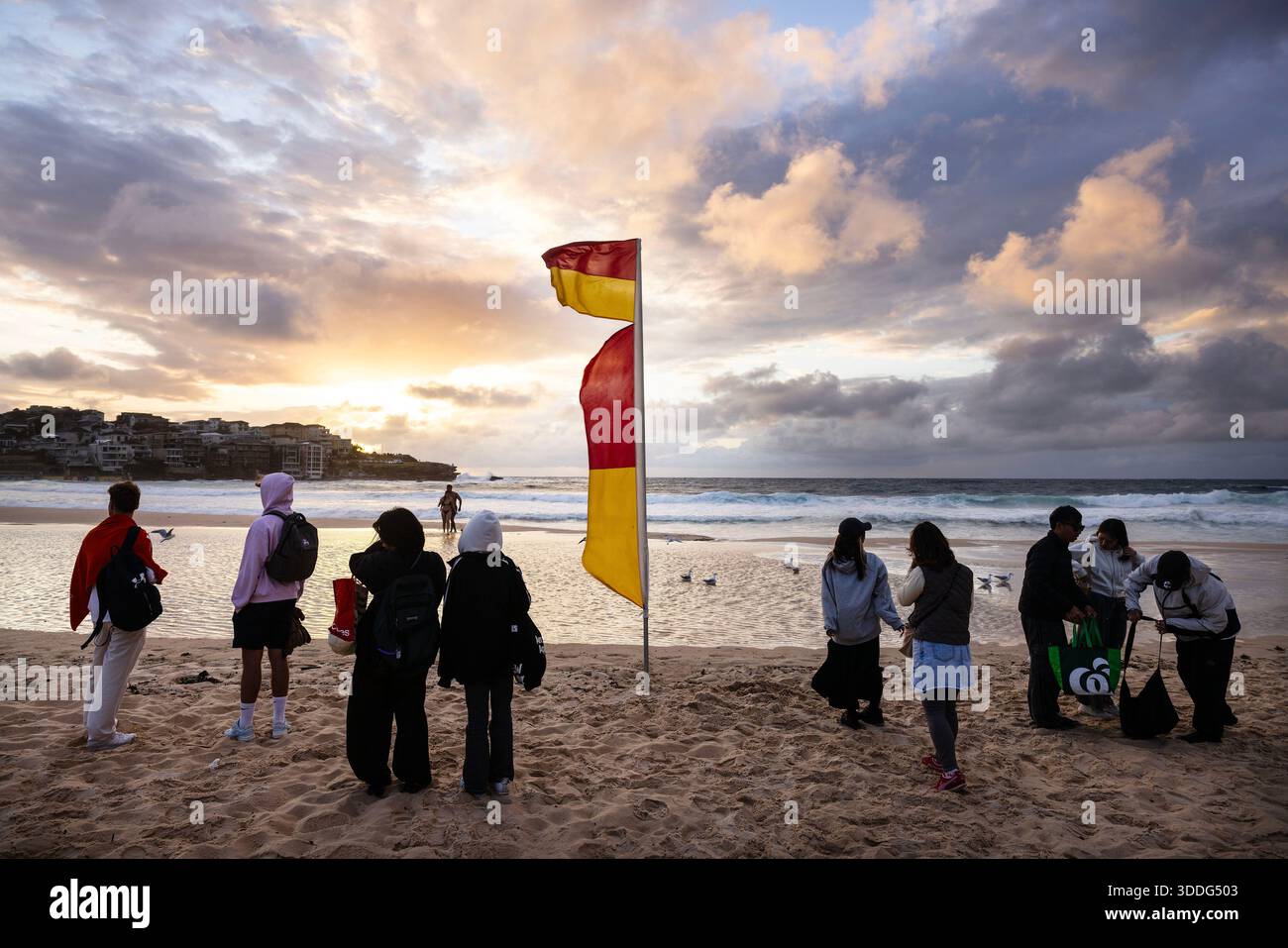 People gather to watch the sunrise on New Years Day at Bondi Beach, in ...