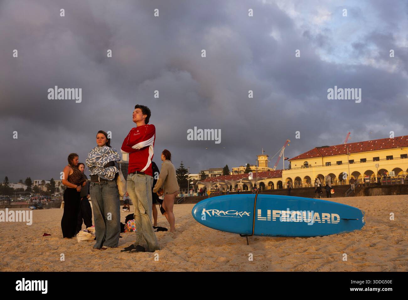 People gather to watch the sunrise on New Years Day at Bondi Beach, in ...