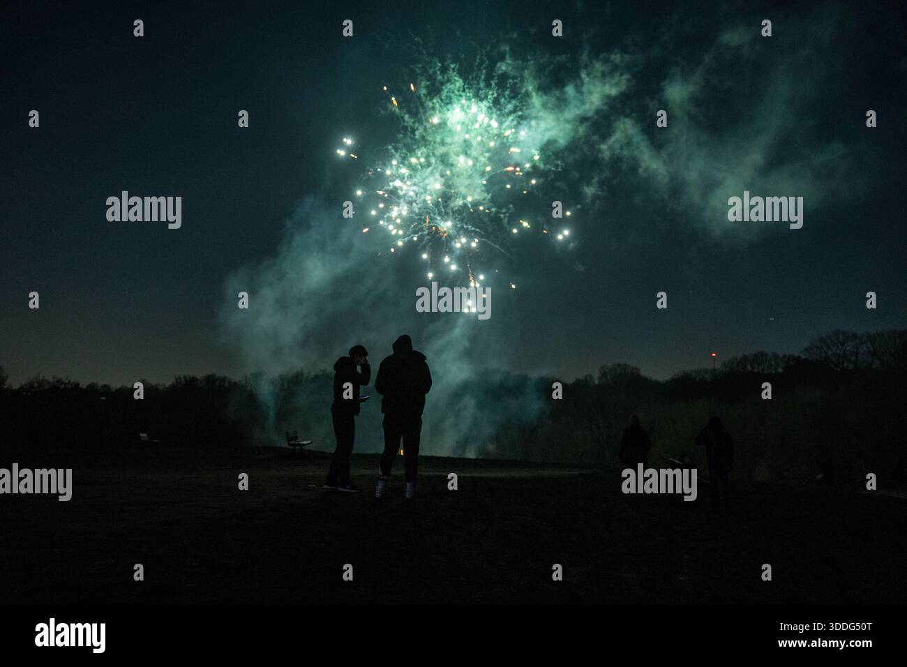 People watch as fireworks explode over Parliament Hill Viewpoint a ...
