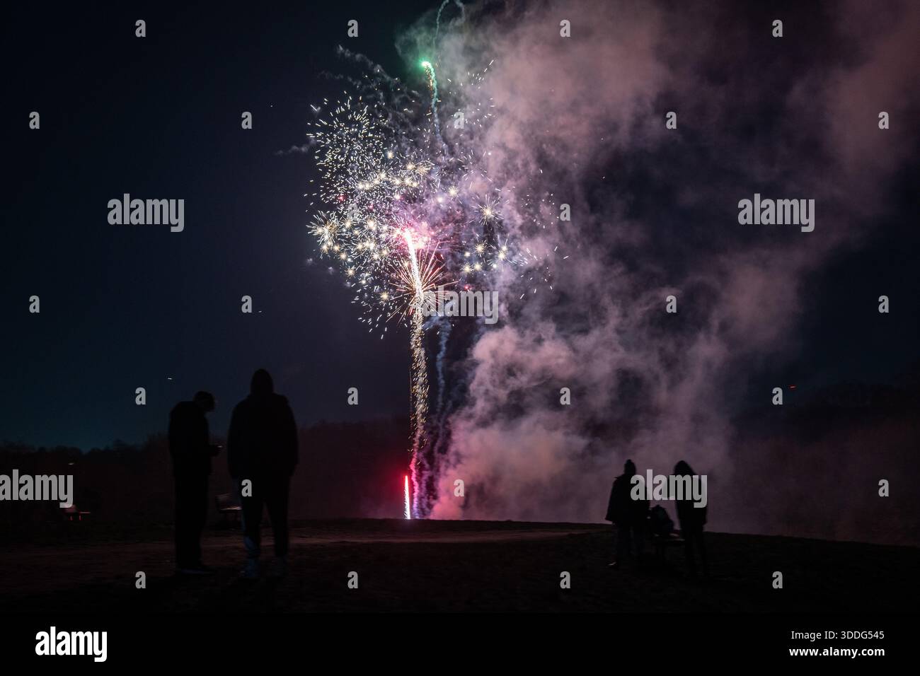 People watch as fireworks explode over Parliament Hill Viewpoint a ...