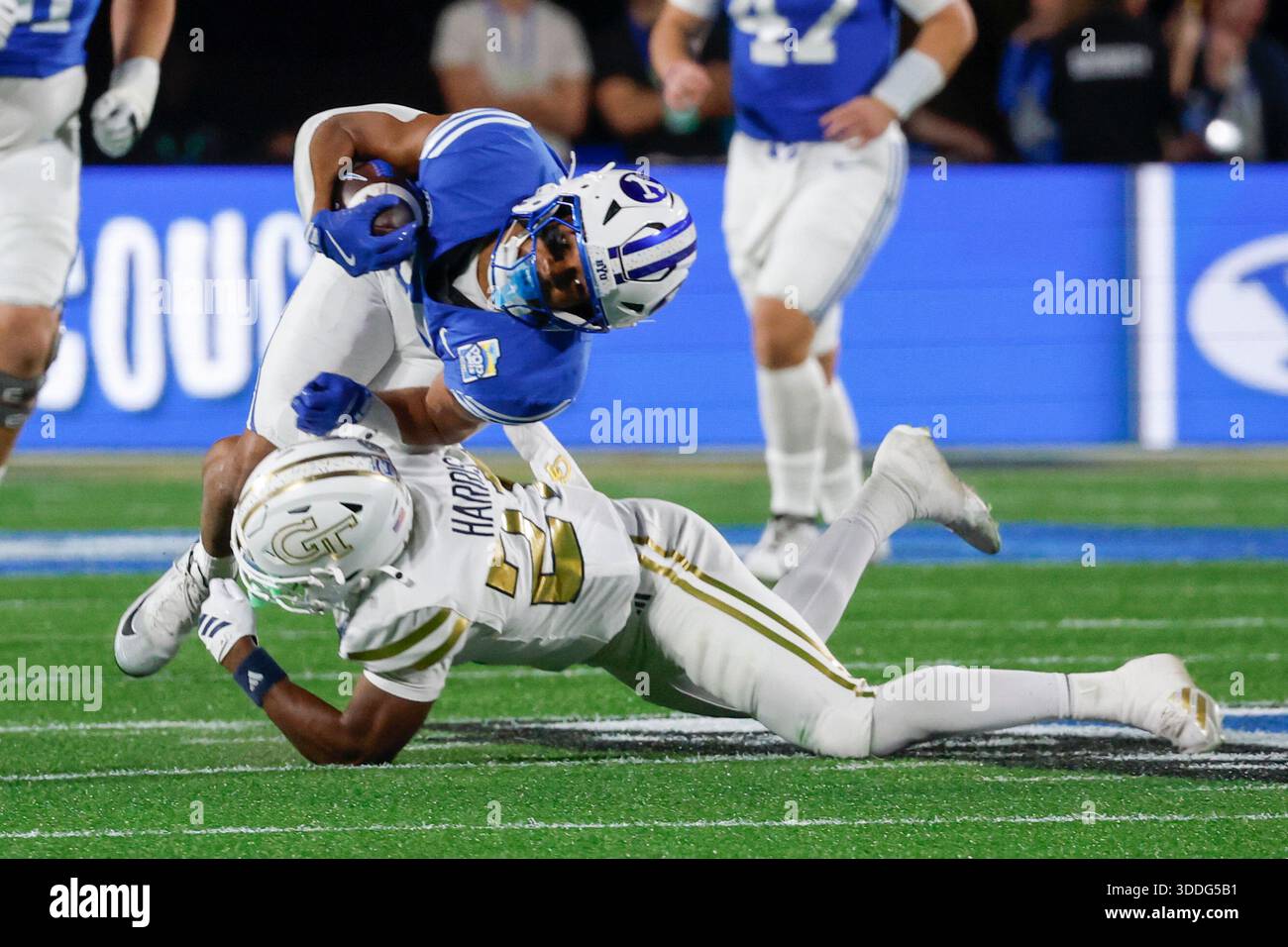 BYU running back Jovesa Damuni, left, is tackled by Georgia Tech ...