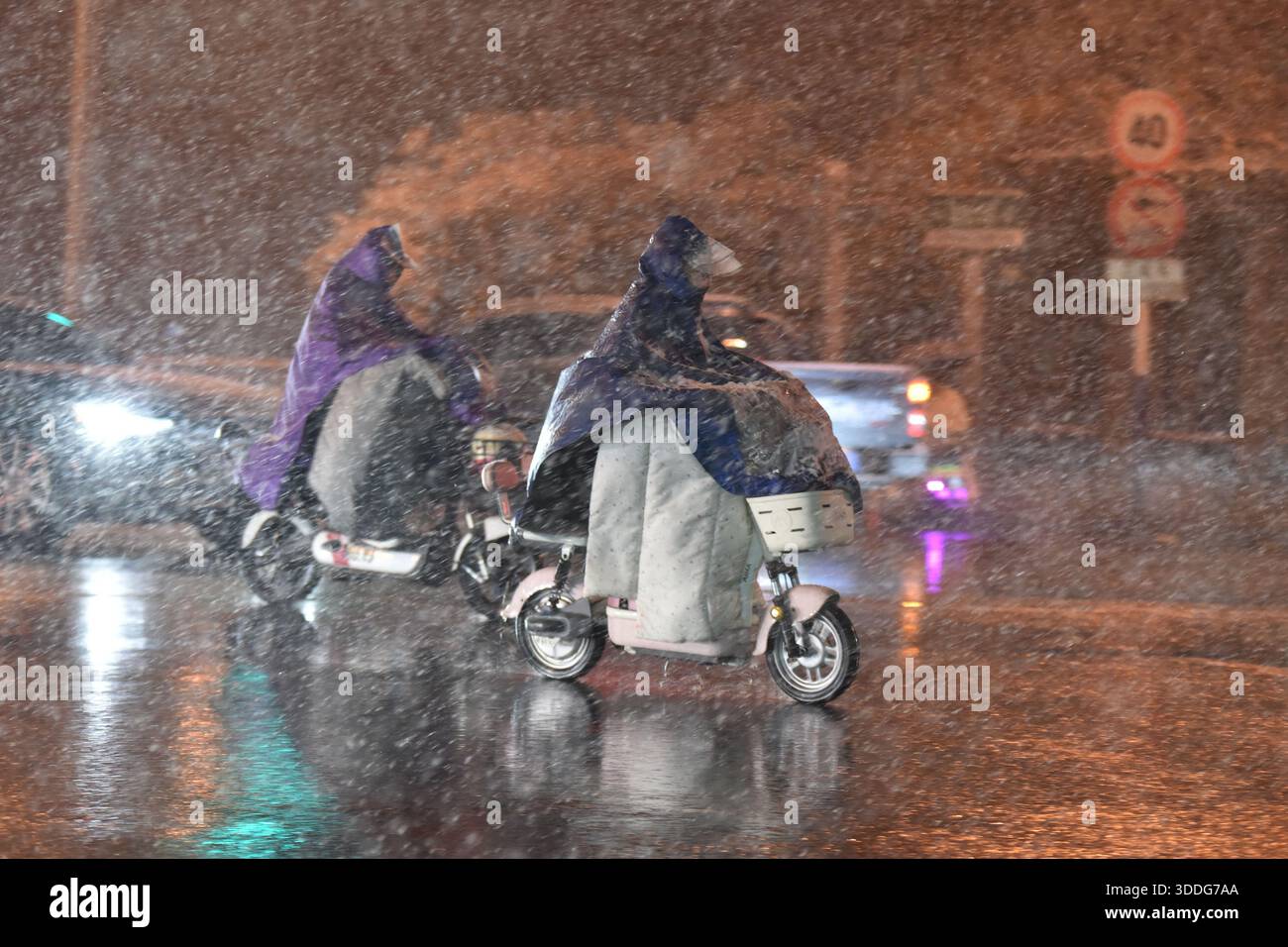 FUYANG, CHINA - DECEMBER 31, 2025 - Pedestrians braved the snow to ride ...