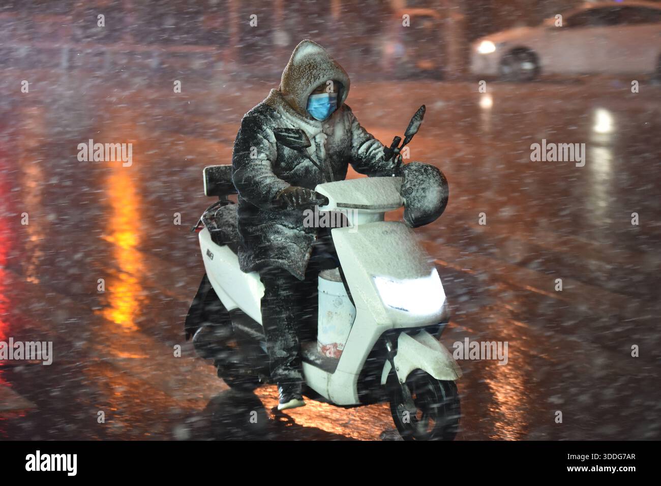 FUYANG, CHINA - DECEMBER 31, 2025 - Pedestrians braved the snow to ride ...