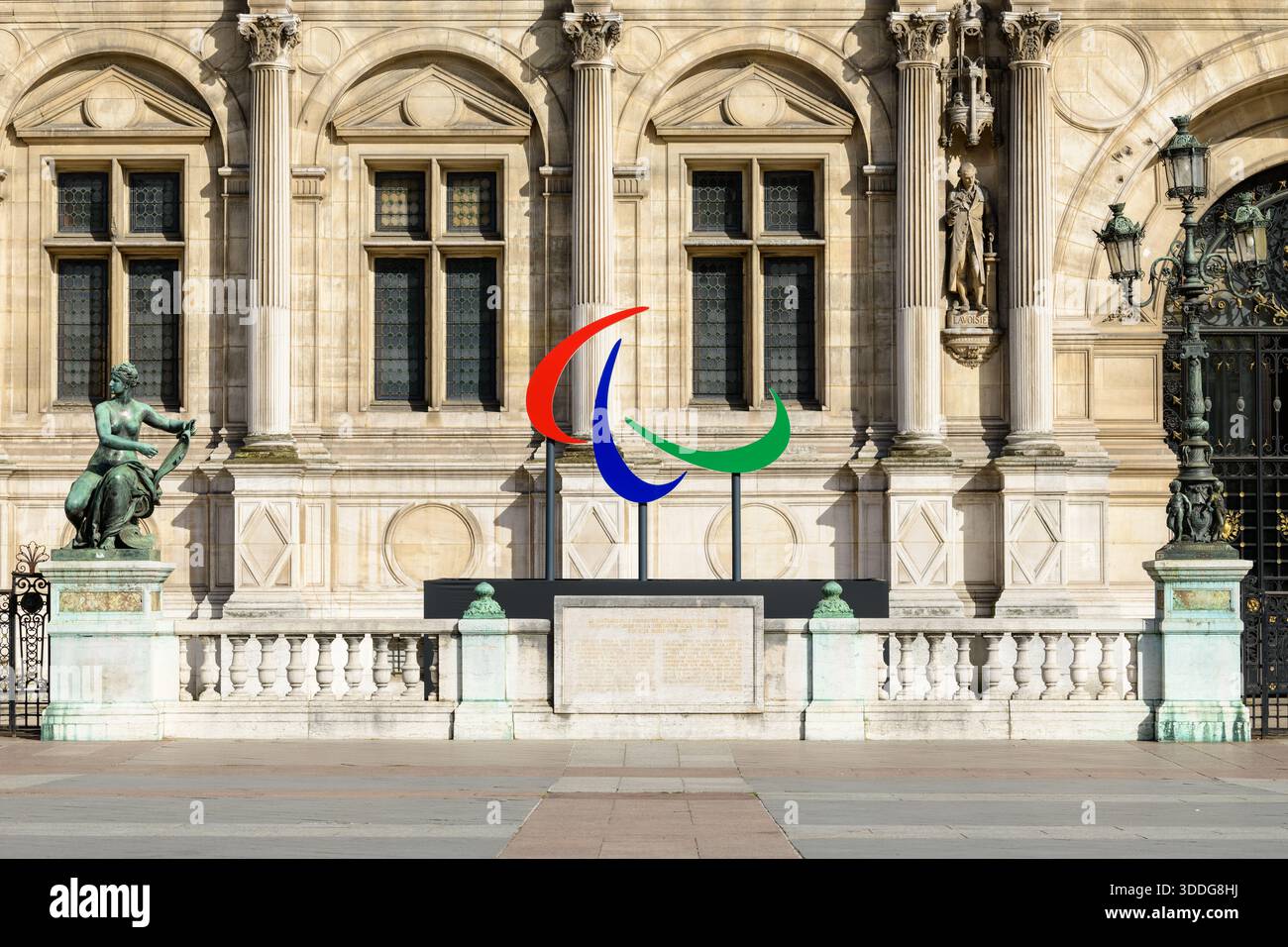 Colorful Paralympic symbol displayed on a stone pedestal between bronze ...