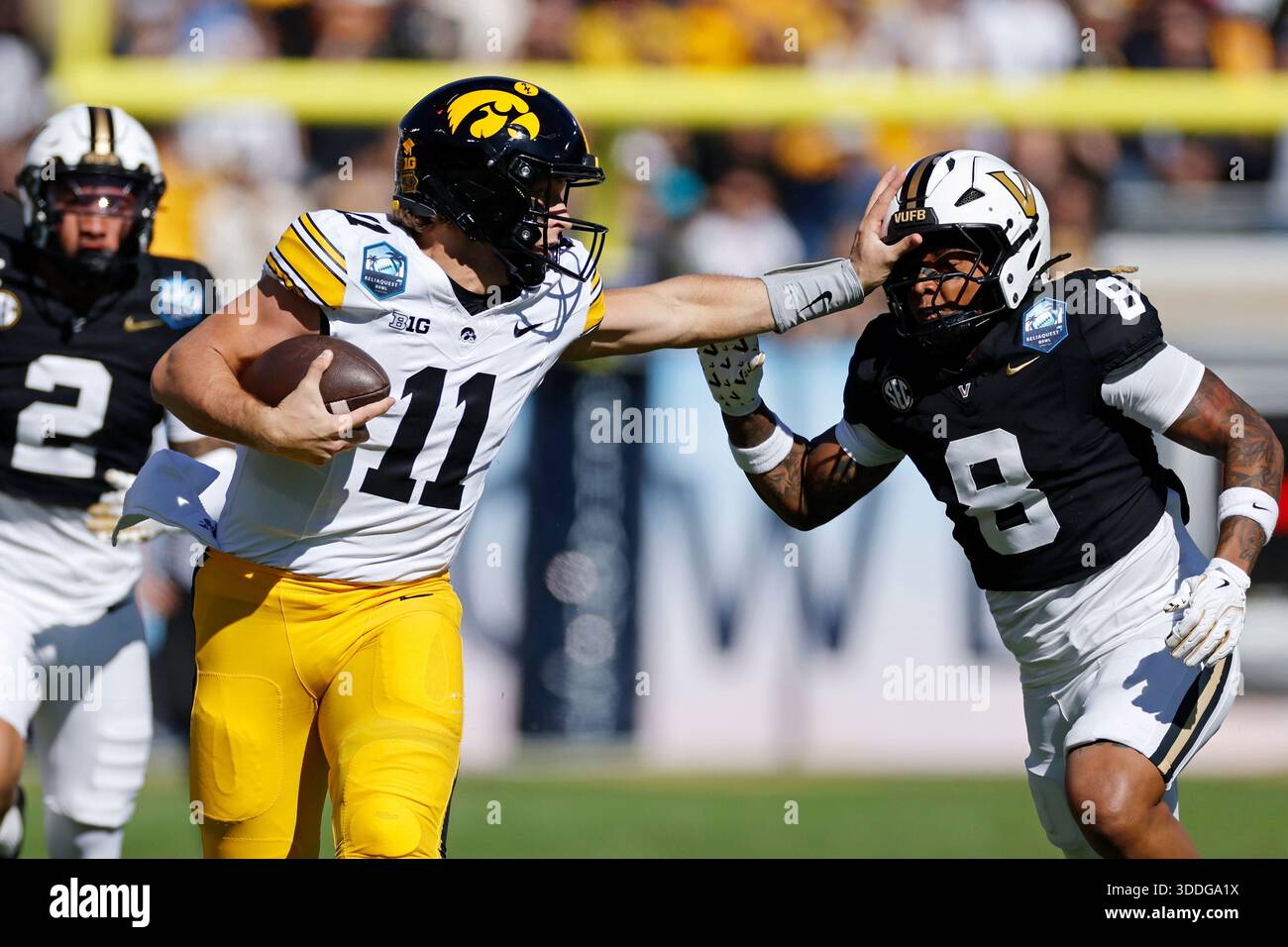 TAMPA, FL - DECEMBER 31: Mark Gronowski #11 of the Iowa Hawkeyes runs ...