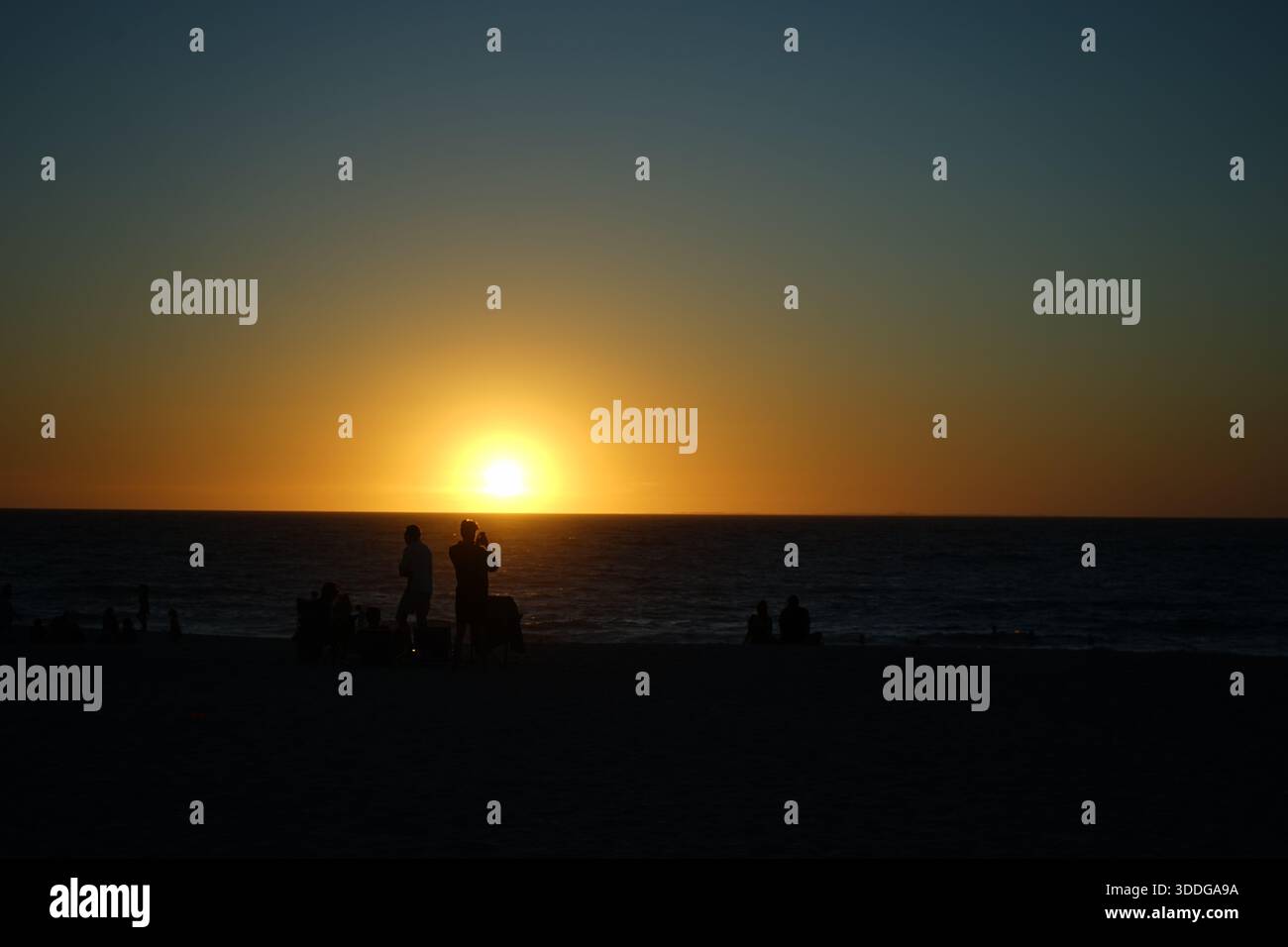 Perth, Australia - December 31, 2025: People watch the sunset on a ...