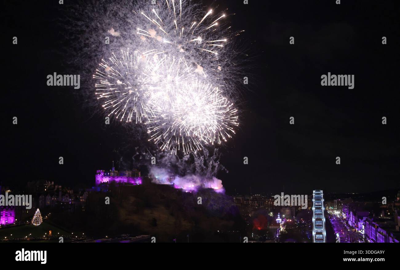Fireworks explode over Edinburgh Castle during the Hogmanay New Year ...