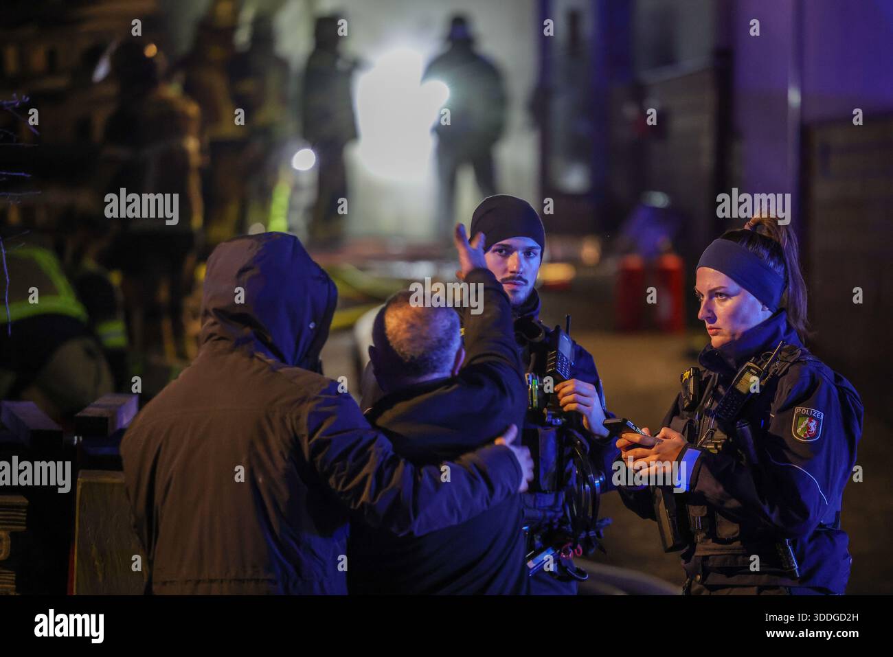 Police officers speak to the owner of a warehouse during a fire on New ...