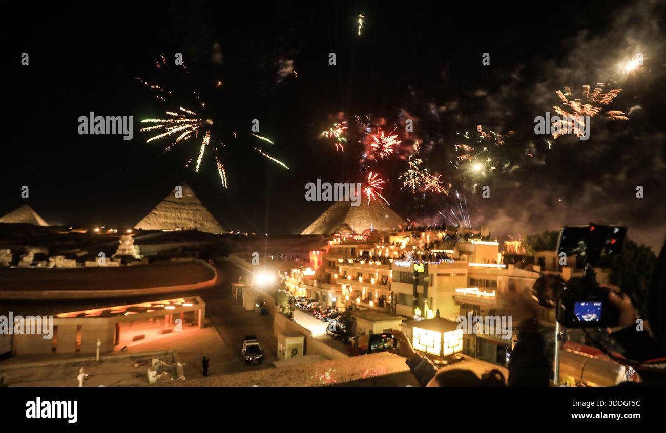 Fireworks light up the sky above the Great Pyramids of Giza during New ...