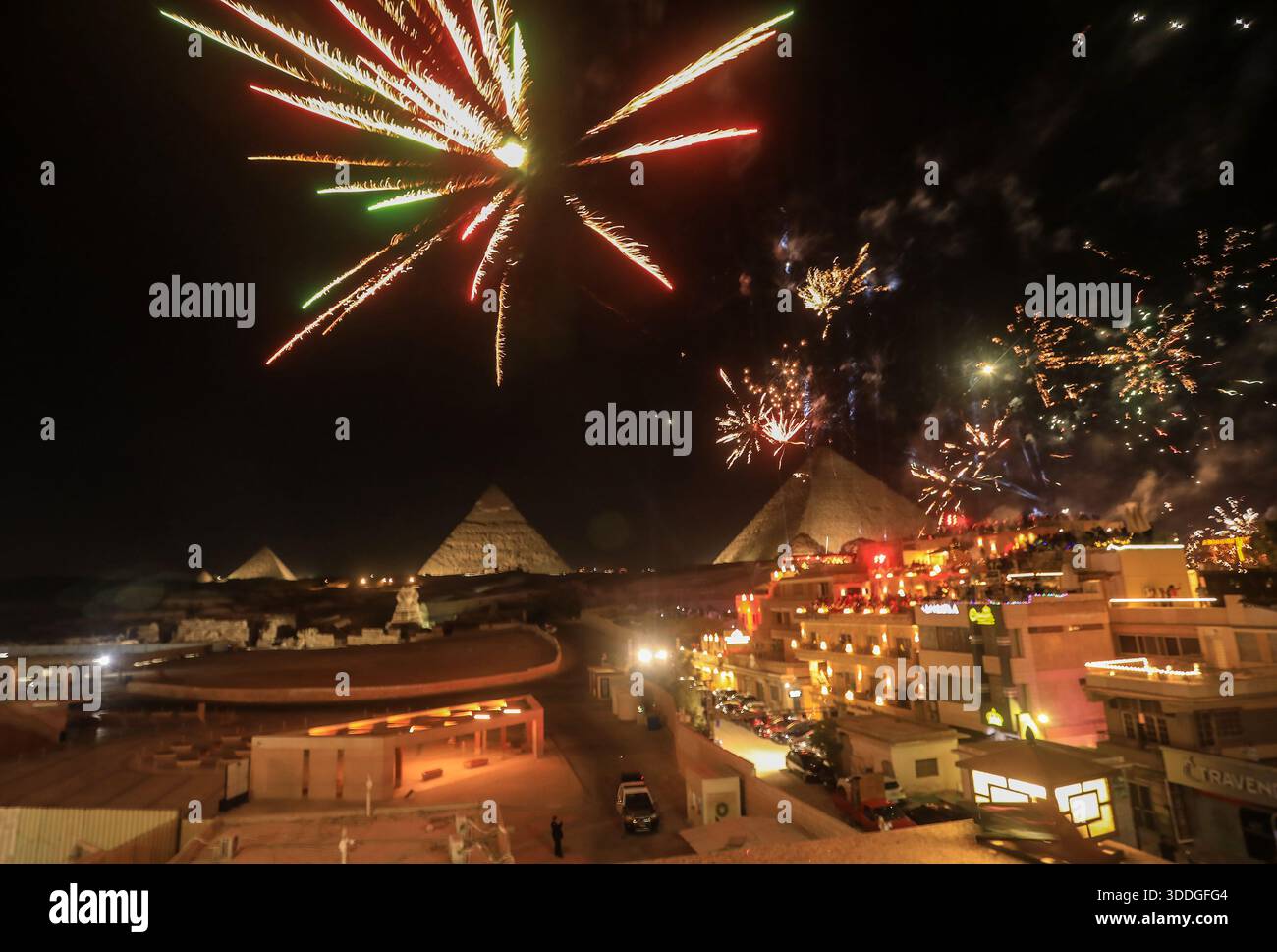 Fireworks light up the sky above the Great Pyramids of Giza during New ...