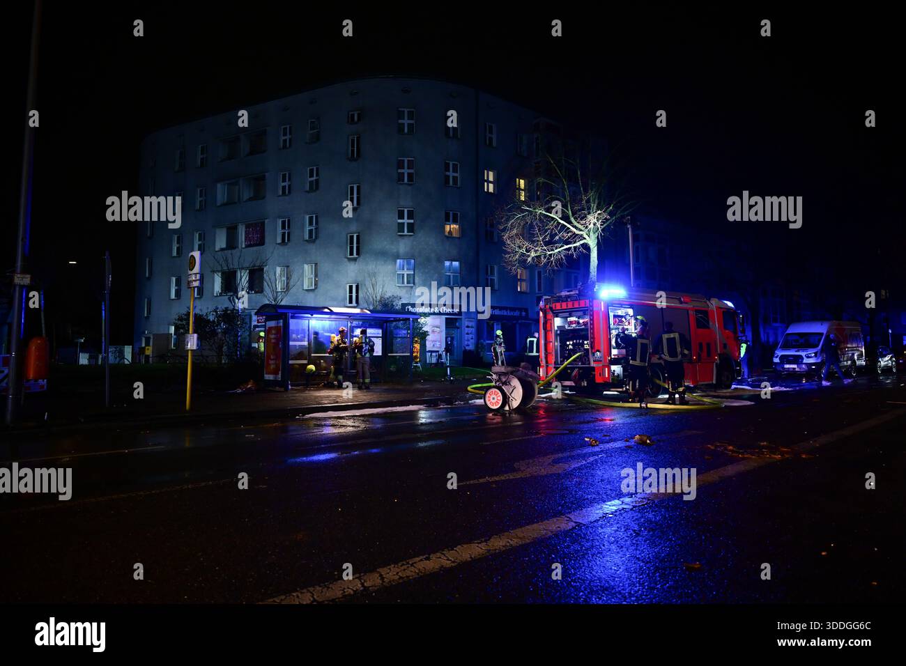 01 January 2026, Berlin: Fire department vehicles stand in front of a ...