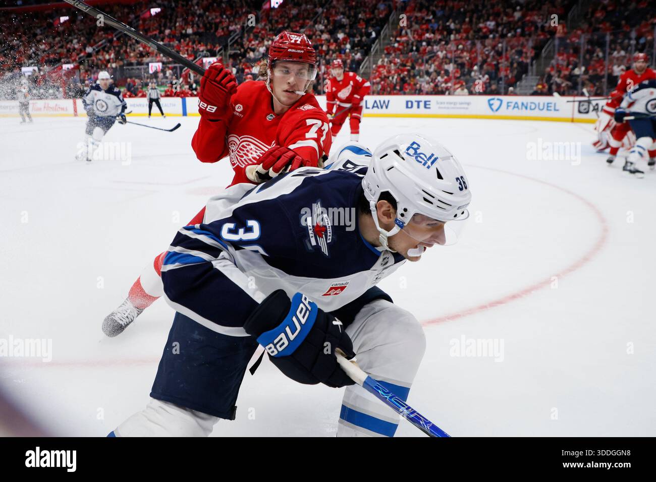 Detroit Red Wings defenseman Simon Edvinsson, back, pursues Winnipeg ...