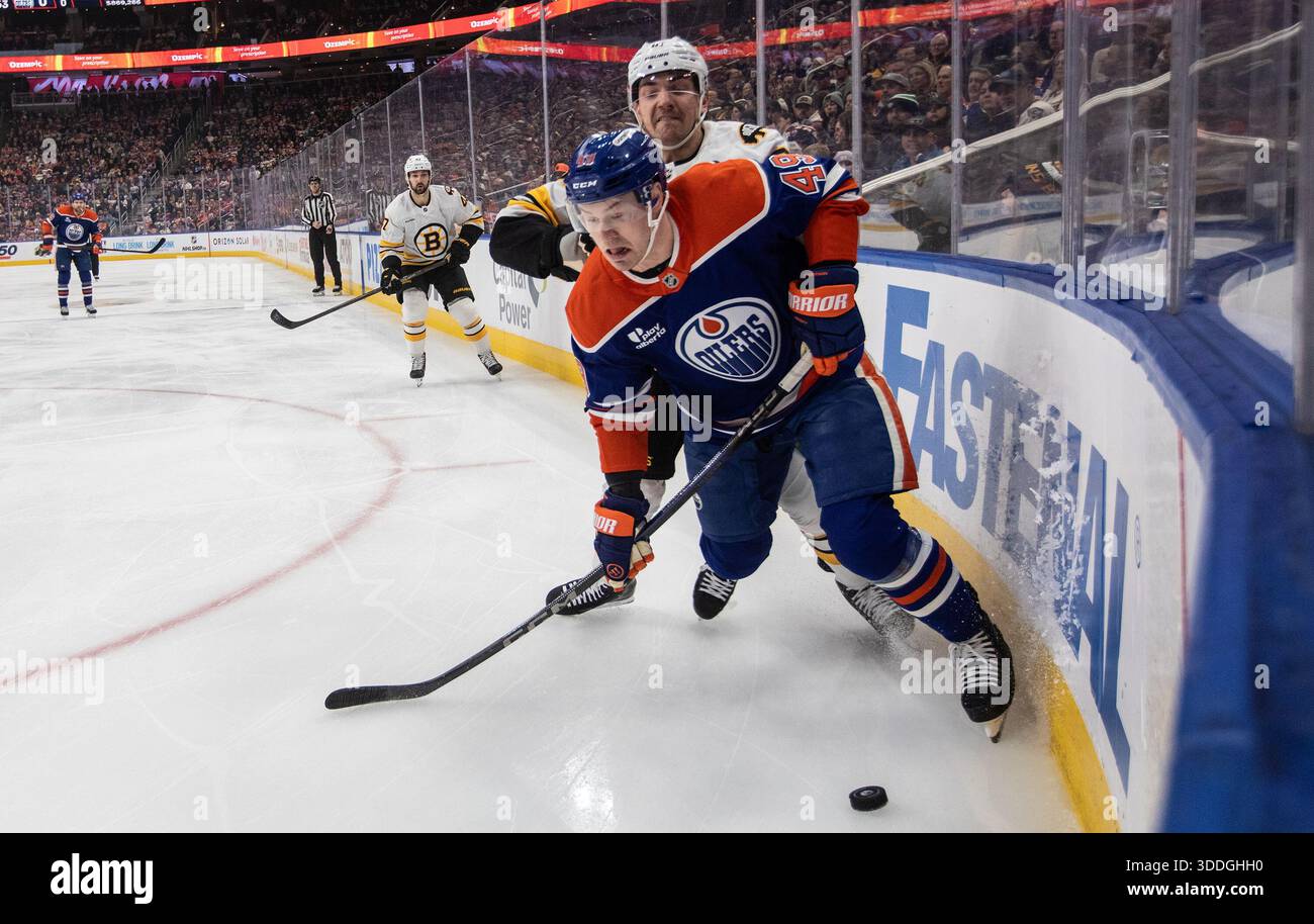 Boston Bruins' Mikey Eyssimont (81) and Edmonton Oilers' Ty Emberson ...