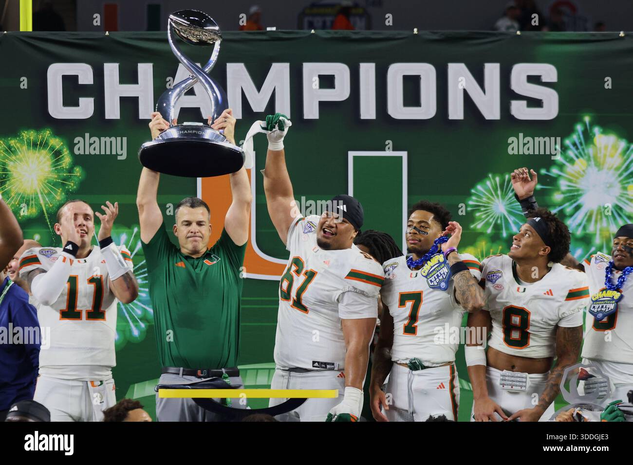 Miami head coach Mario Cristobal holds the Field Scovell Trophy ...