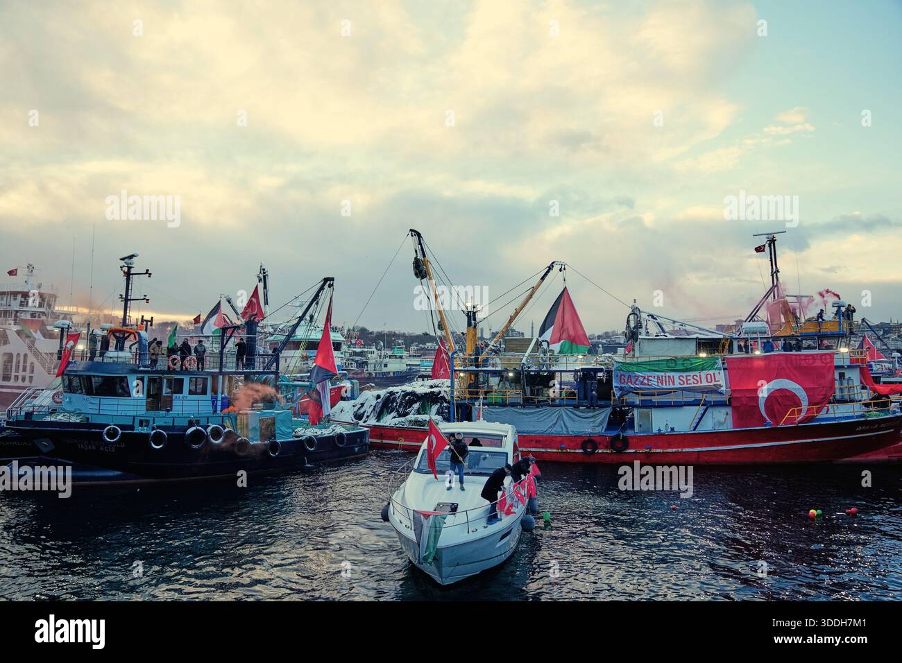 Boats carrying Turkish and Palestinian flags sail along the Golden Horn ...