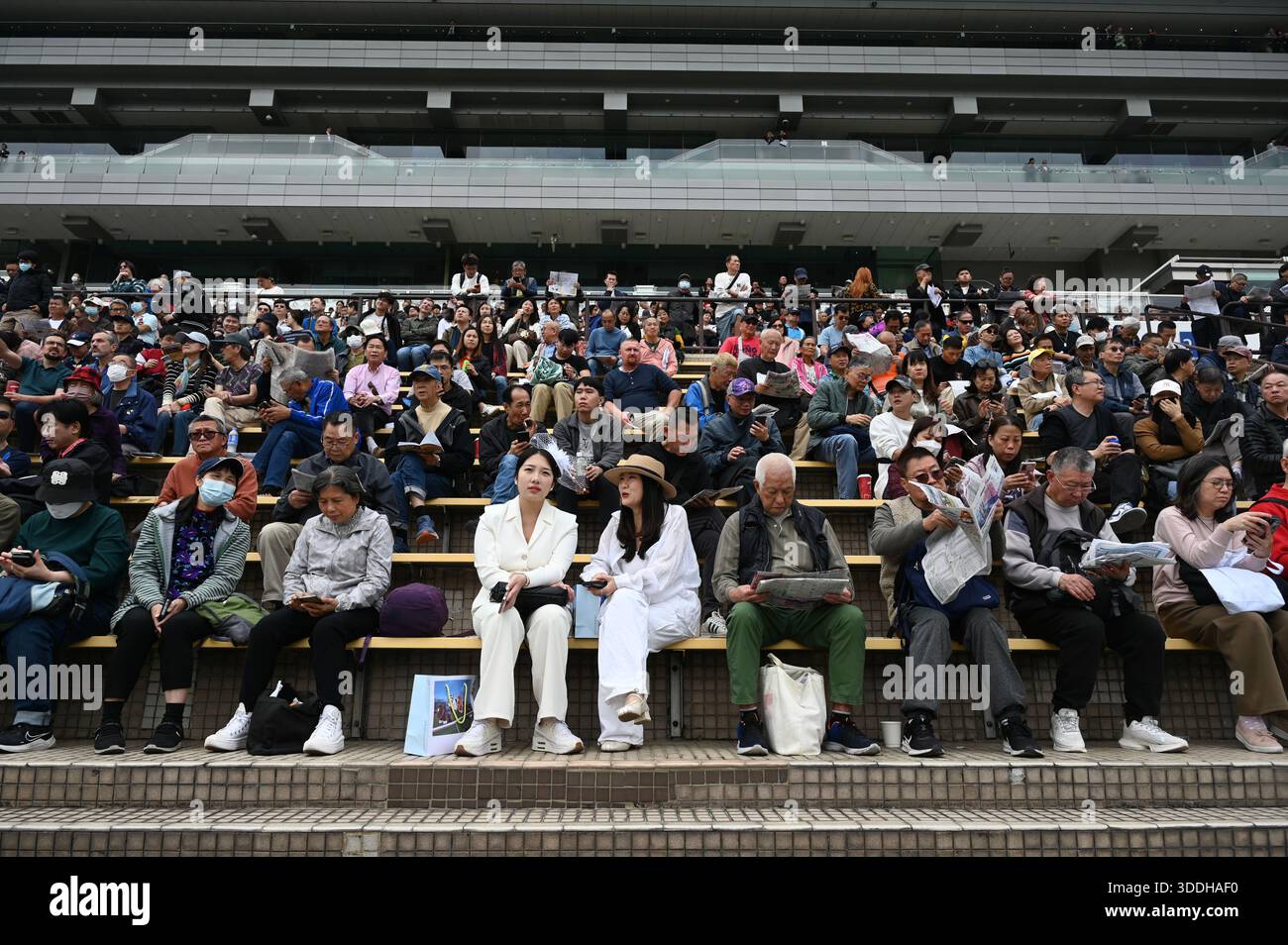 A general view showing the people watching horse racing at Sha Tin ...