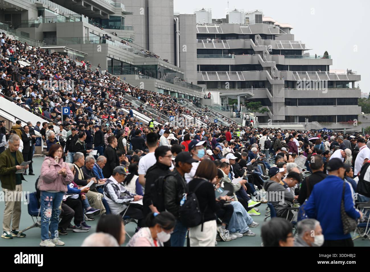 A general view showing the people watching horse racing at Sha Tin ...