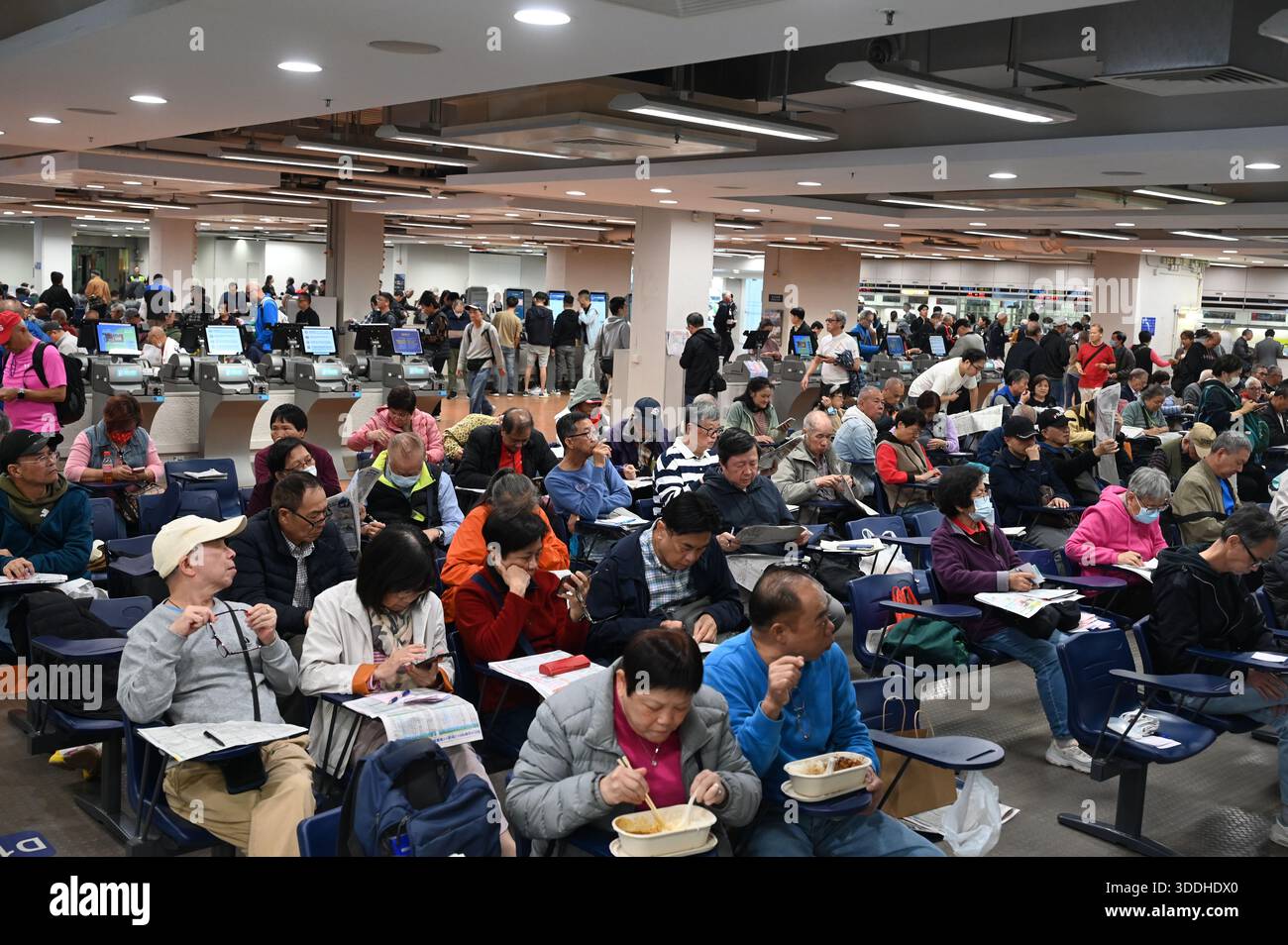 A general view showing the people watching the race information at Sha ...