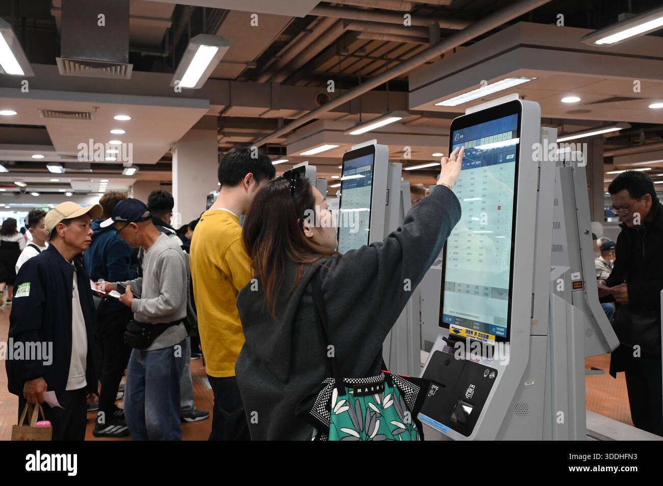 A general view showing the people buying lottery tickets at Sha Tin ...