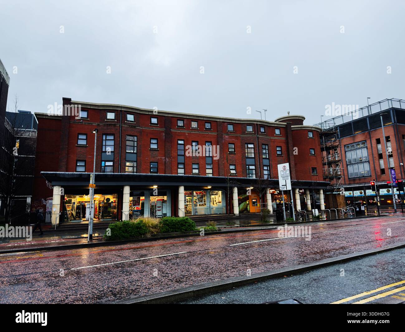 Manchester, UK - December 06, 2025: Wet street in Manchester with red ...