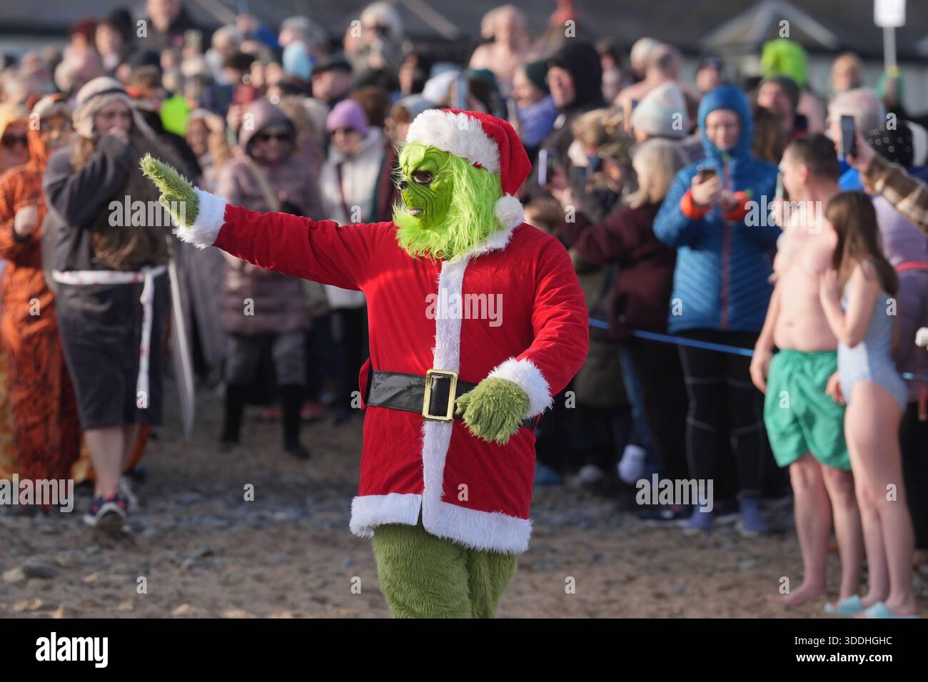 Swimmers take part in the annual New Year’s Day charity swim on Bray ...