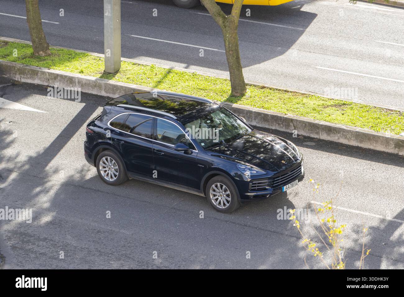 Black porsche cayenne suv parked parallel to a curb on an urban street ...